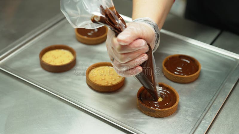 Chef Adding Melted Chocolate in Piping Bag To the Baked Cookies on a ...