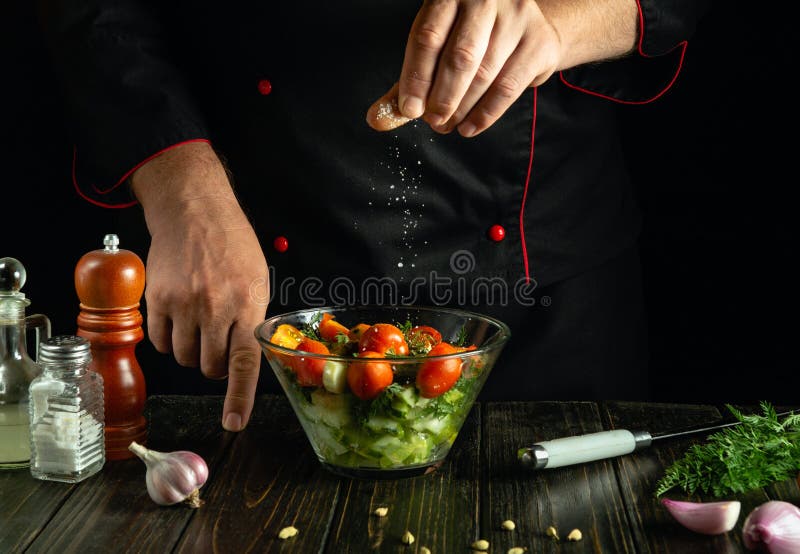 Chef Adding Salt To Fresh Chopped Vegetables in a Bowl by Hands ...