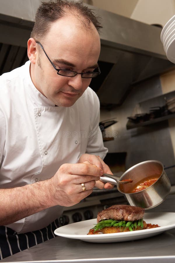 Chef Adding Seasoning To Dish in Restaurant Stock Photo - Image of ...