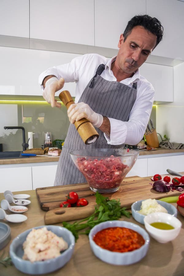 The Cook Adding the Spices in a Bowl with the Meat, Onion and Bacon ...