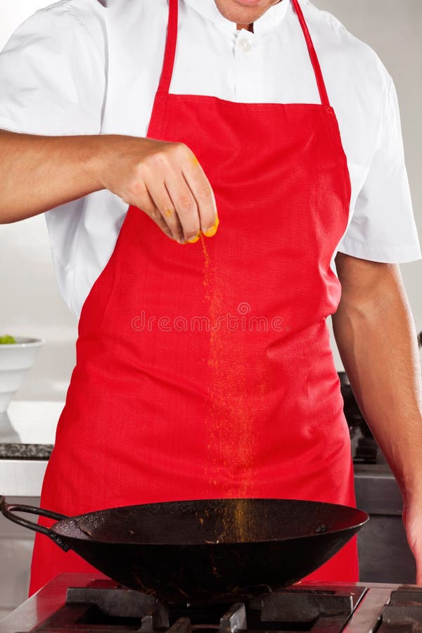 Chef Adding Seasoning To Dish in Restaurant Stock Photo - Image of ...