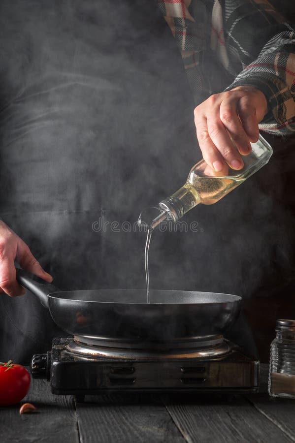 The Chef Adds Olive Oil To Pan while Cooking. Working Environment on ...