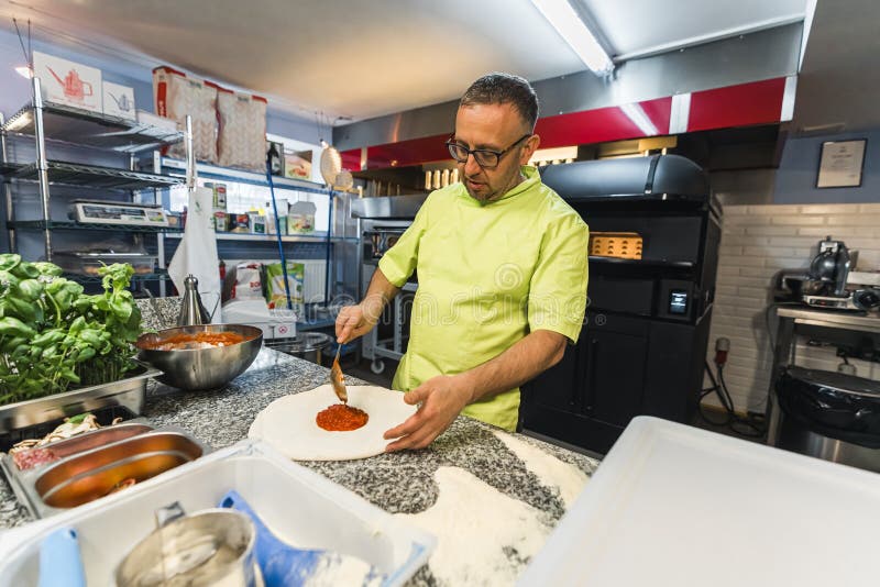 Chef Applying Tomato Sauce on the Pizza Dough, Pizza Making Process ...