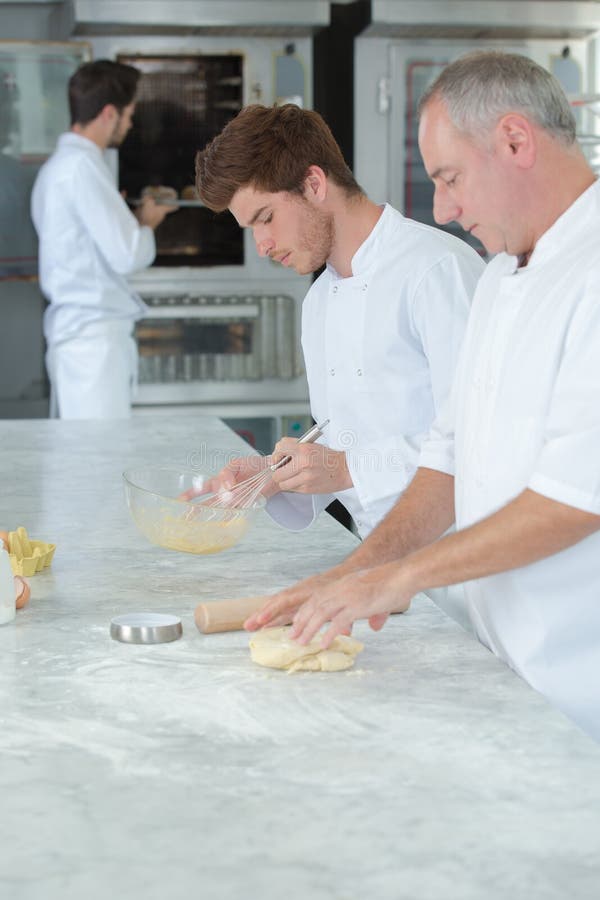 Chef and Apprentice Preparing Cake Together Stock Image - Image of ...