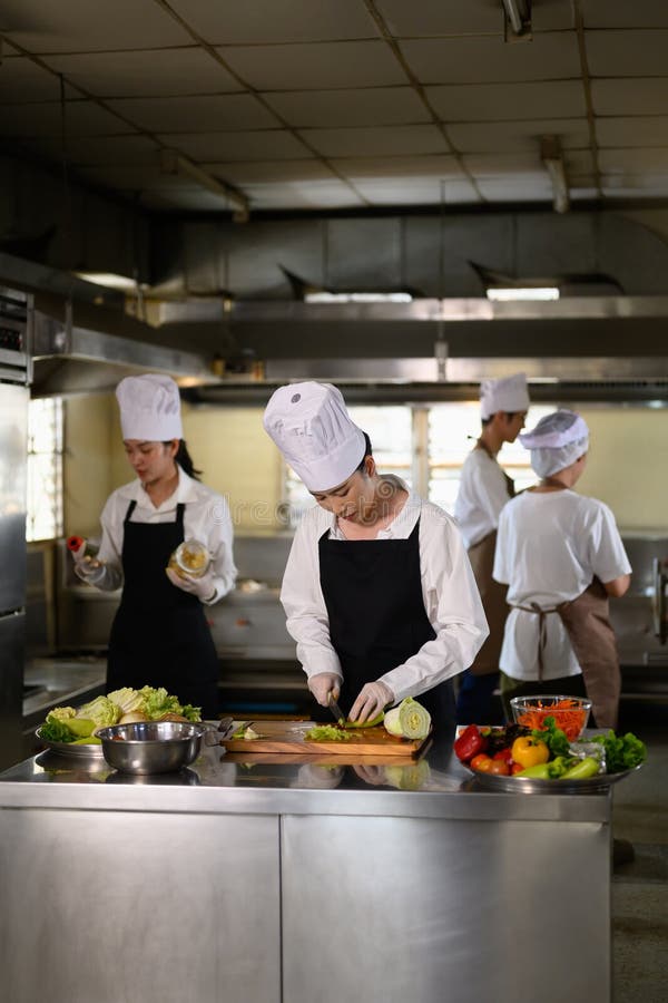 Chef Apprentice Working on Vegetable Preparation in a Busy Kitchen ...