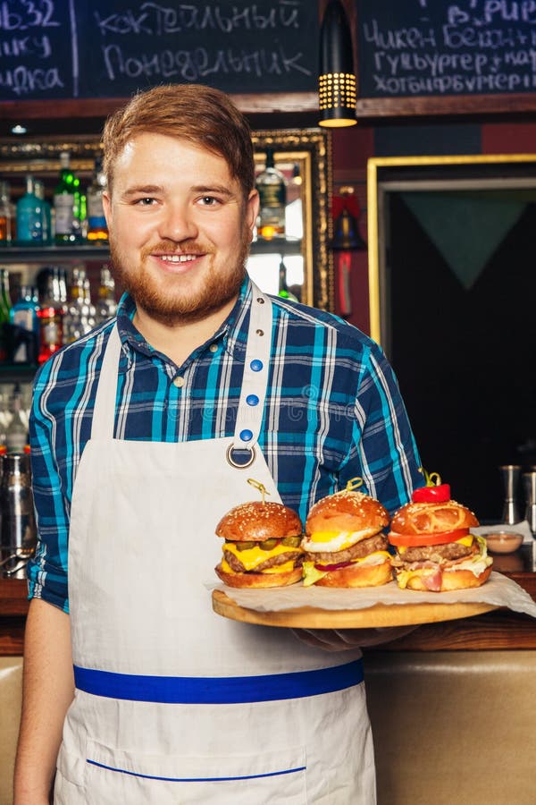Chef in Black Uniform Presenting a Tray with Burger Stock Photo - Image ...