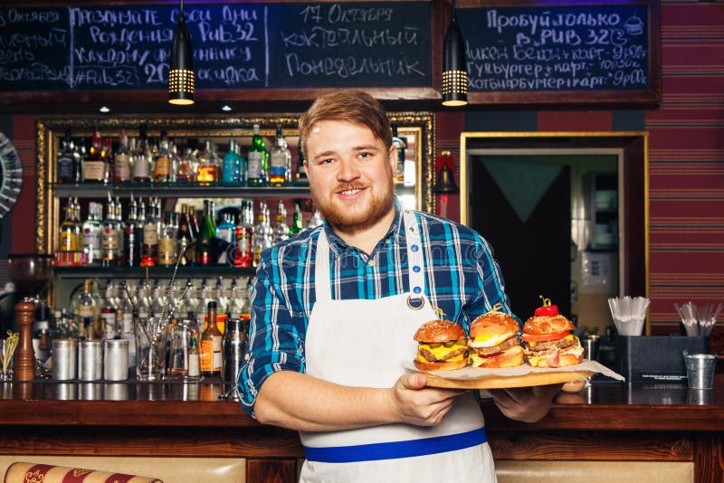 Chef in Apron Presenting a Tray with Different Delicious Burgers Stock ...