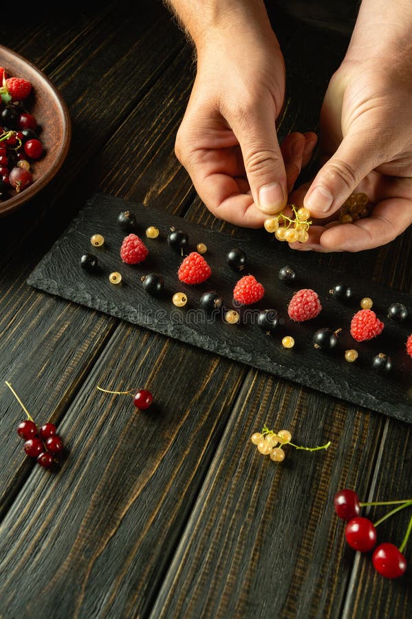 A Chef Arranges Ripe Berries on a Sorting Board before Serving Dessert ...