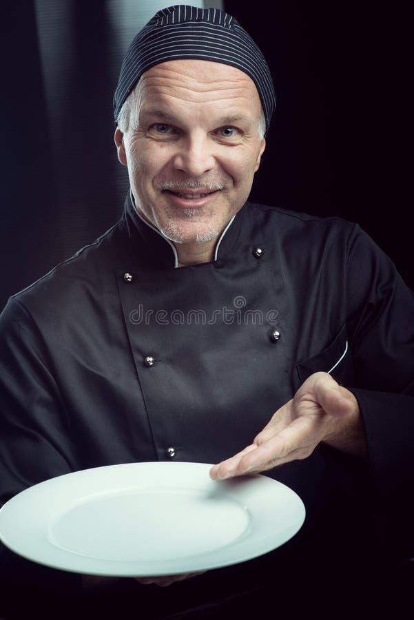 Chef in Black Uniform Showing a Plate Stock Image - Image of kitchen ...