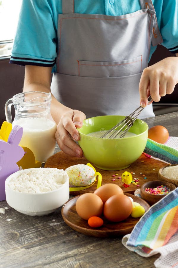 Chef Boy Cooking on a Easter Kitchen Table and Cooking Dough. Stock ...