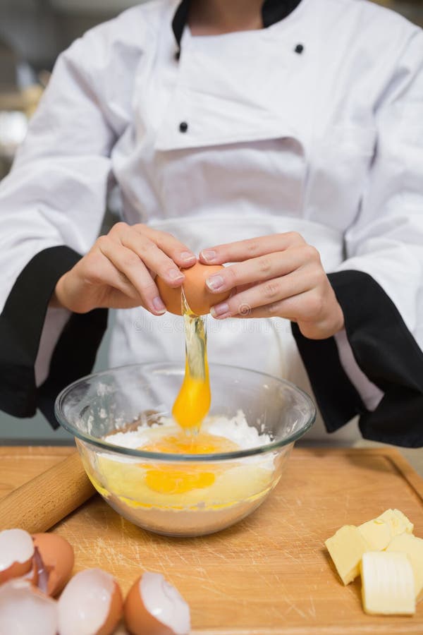 Chef Breaking Eggs into Flour Stock Image - Image of making, holding ...