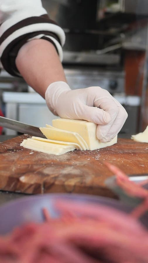 Chefs Prepare and Slice Cheese in a Busy Kitchen Environment Stock ...