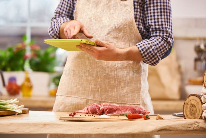 Chef Butcher Preparing Recipe with Digital Tablet in the Modern ...