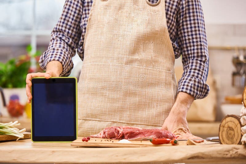 Chef Butcher Showing Digital Tablet in the Modern Authentic Kitchen ...