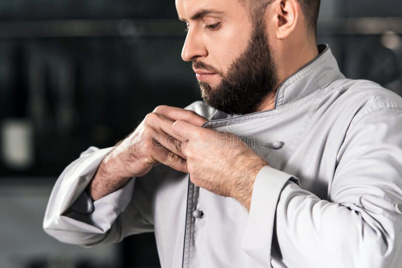 Chef Button Uniform at Kitchen Restaurant. Concentrated Chef Buttoning ...