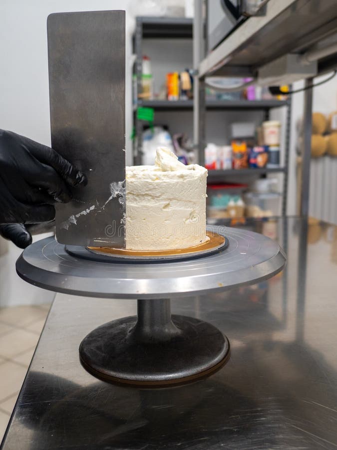 Chef Cake Smoothing a Frosted Cake with Buttercream with Spatula and ...