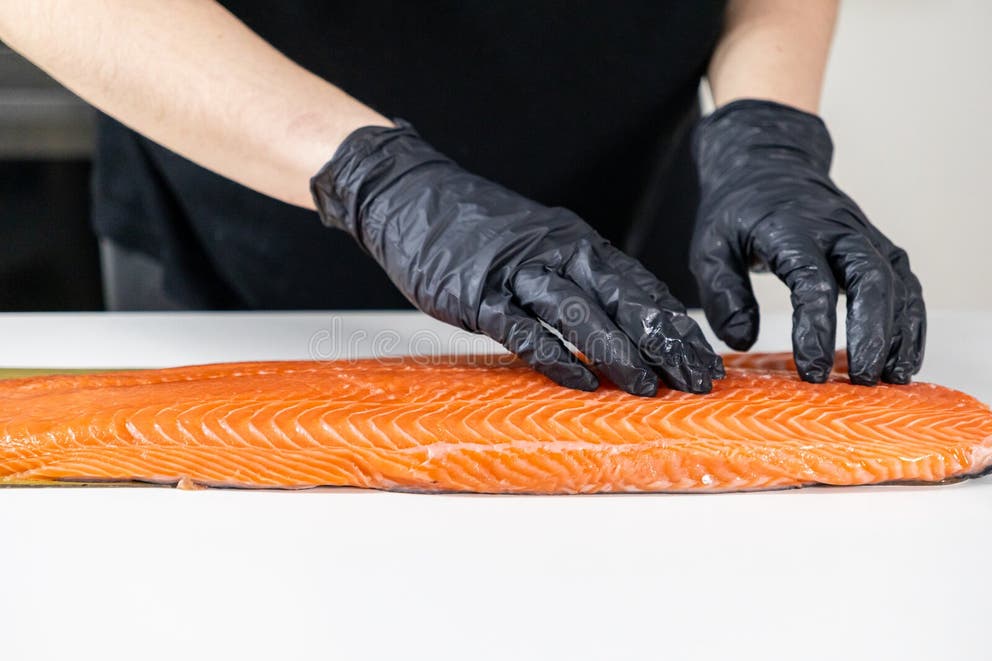Chef Checking for Fish Bones in Fresh Salmon Fillet Using Black Gloves ...