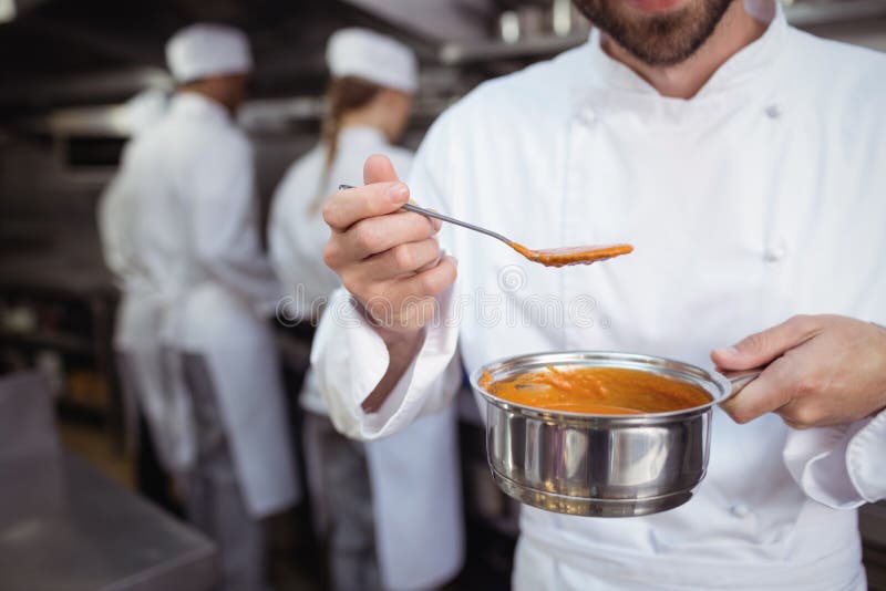 Chef Checking Food from Spoon in Kitchen at Restaurant Stock Image ...