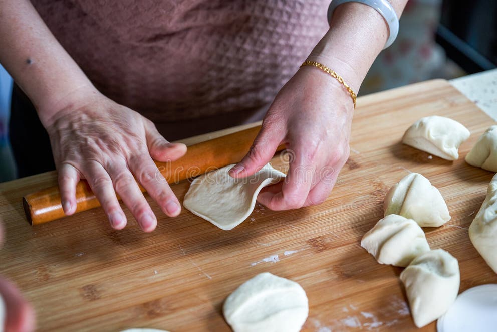 A Chef in a Chinese Kitchen is Making Bun Skins with a Rolling Pin ...
