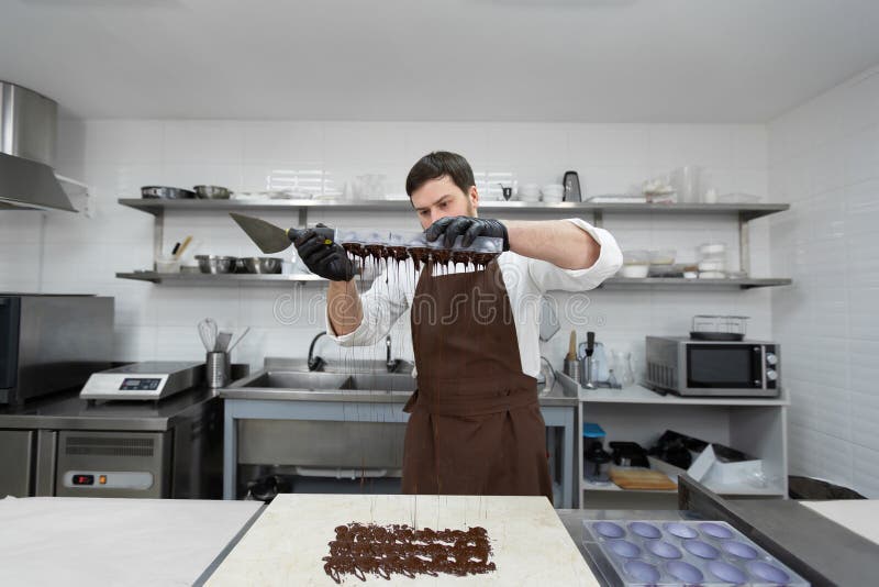 Chef or Chocolatier Makes Sweet Chocolates in a Professional Kitchen ...
