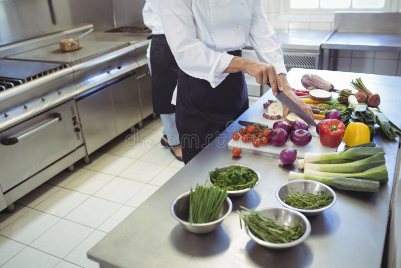 Chef chopping vegetables stock photo. Image of indoors - 92567496