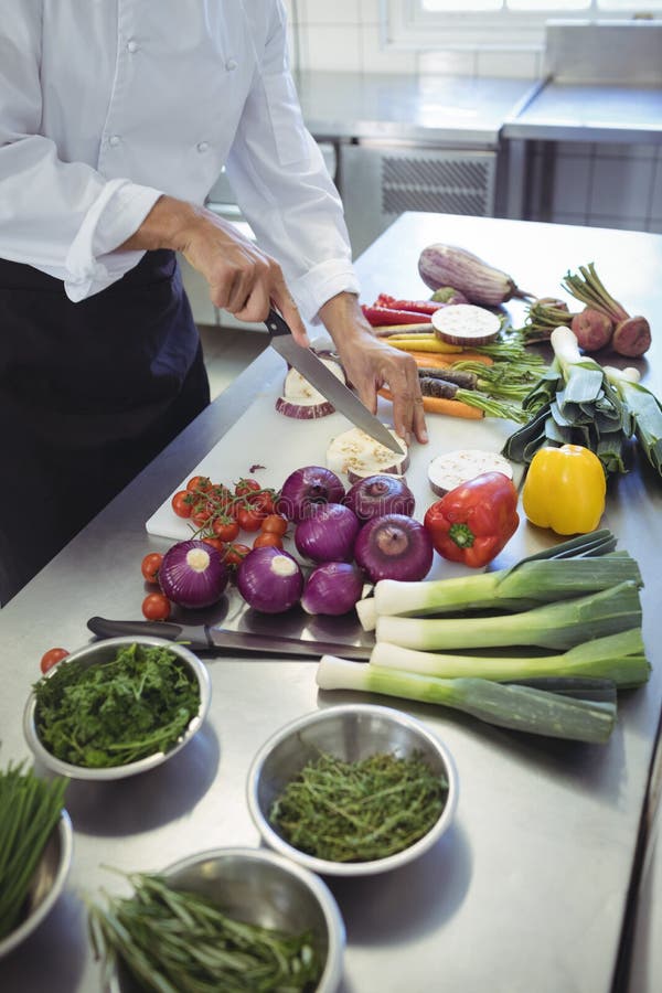 Chef chopping vegetables stock photo. Image of indoors - 92567496