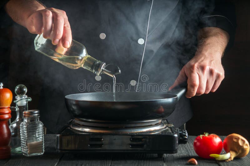 The Chef or Cook Adds Olive Oil To the Pan while Cooking. Working ...