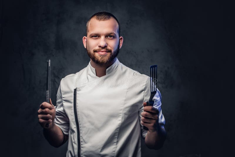 Chef Cook Holds a Knife Over Dark Grey Background. Stock Photo - Image ...