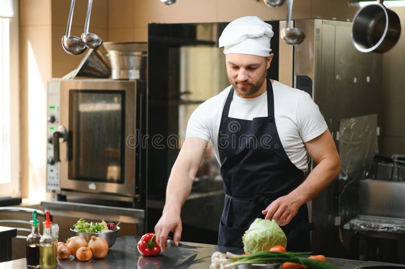 Chef Cook in Uniform Cooking in the Big Cooker at the Restaurant ...