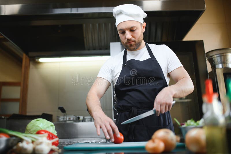 Chef Cook in Uniform Cooking in the Big Cooker at the Restaurant ...