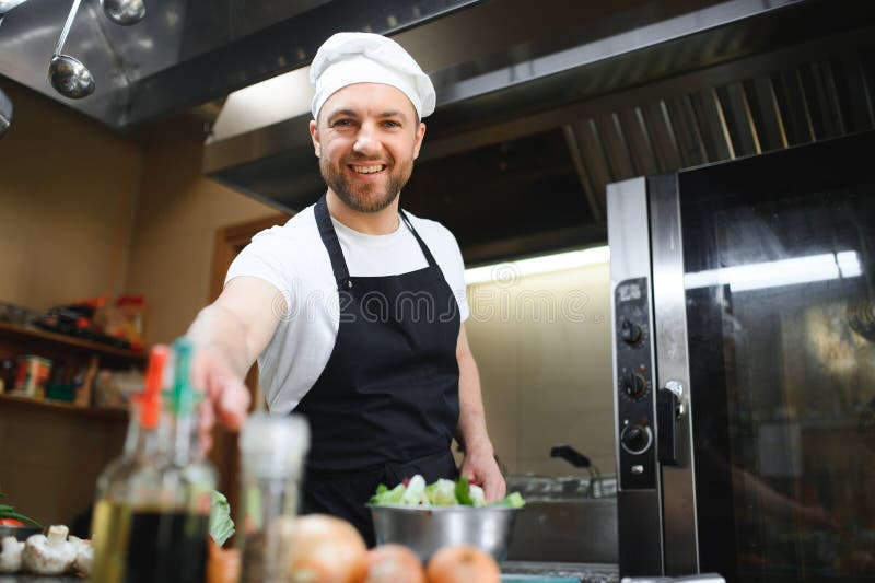 Chef Cook in Uniform Cooking in the Big Cooker at the Restaurant ...