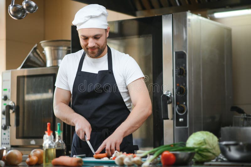 Chef Cook in Uniform Cooking in the Big Cooker at the Restaurant ...
