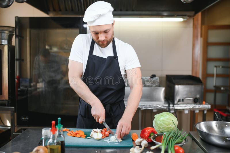 Chef Cook in Uniform Cooking in the Big Cooker at the Restaurant ...