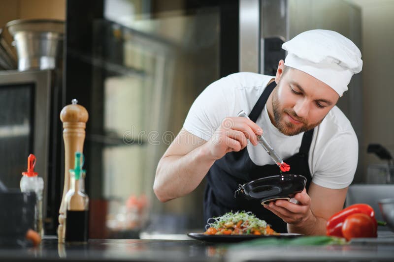 Chef Cook in Uniform Cooking in the Big Cooker at the Restaurant ...