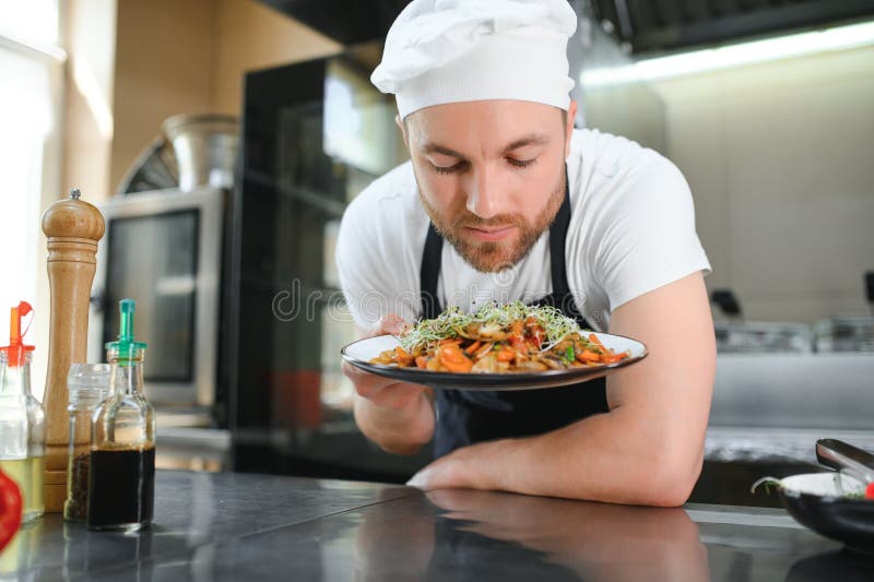 Chef Cook in Uniform Cooking in the Big Cooker at the Restaurant ...