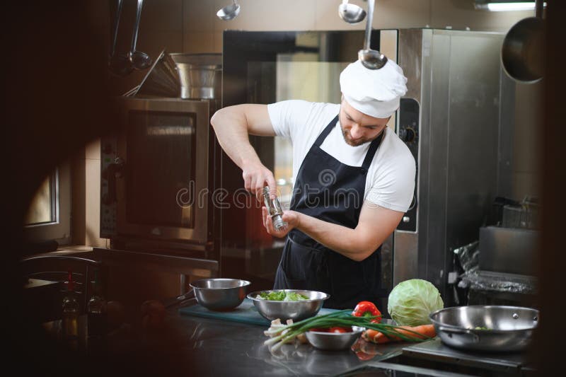 Chef Cook in Uniform Cooking in the Big Cooker at the Restaurant ...