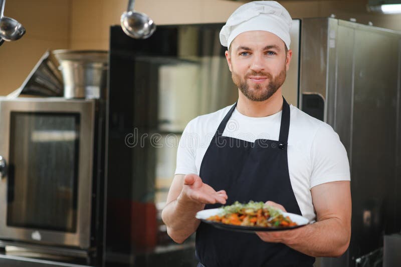 Chef Cook in Uniform Cooking in the Big Cooker at the Restaurant ...