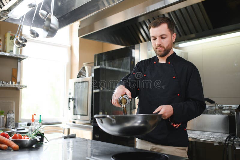 Chef Cook in Uniform Cooking in the Big Cooker at the Restaurant ...
