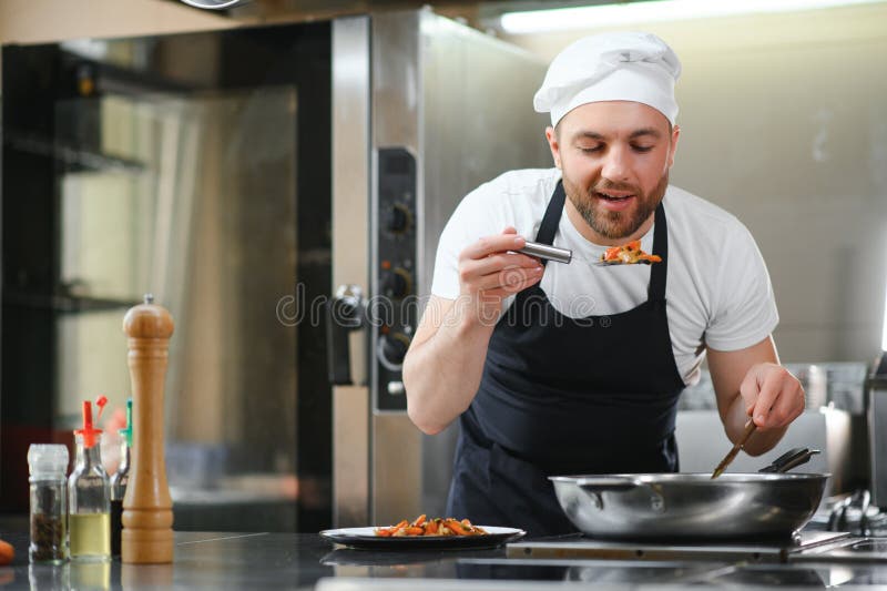 Chef Cook in Uniform Cooking in the Big Cooker at the Restaurant ...