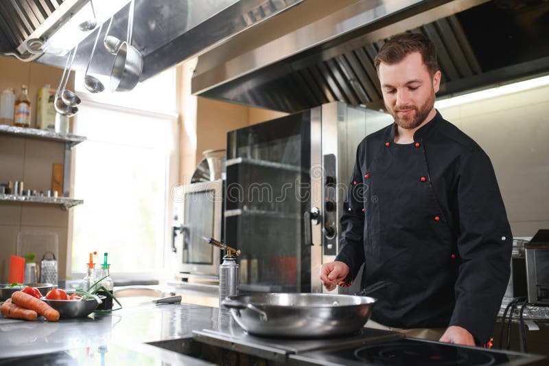 Chef Cook in Uniform Cooking in the Big Cooker at the Restaurant ...