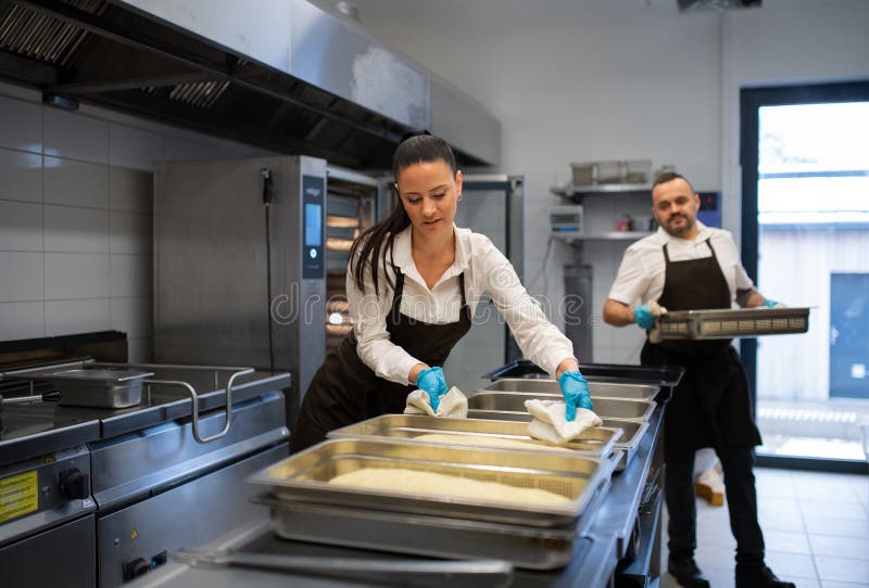 Chef and Cook Working on Their Dishes Indoors in Restaurant Kitchen ...