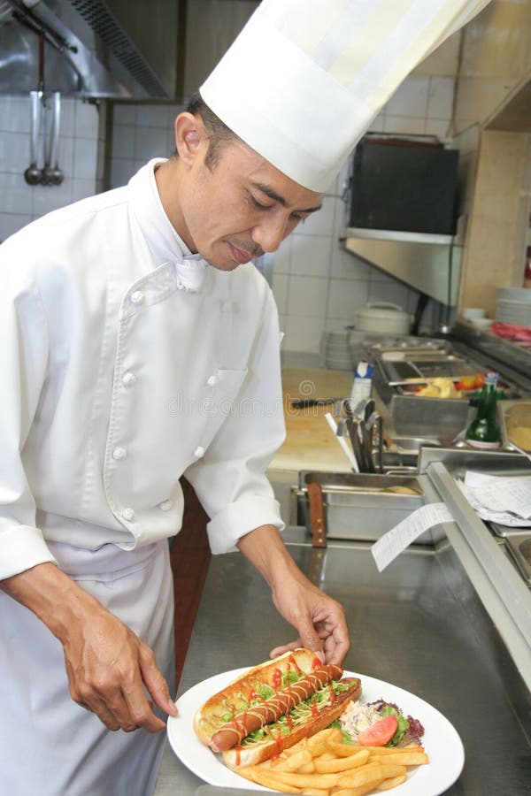 Chef cooking in kitchen stock image. Image of employee - 6032009