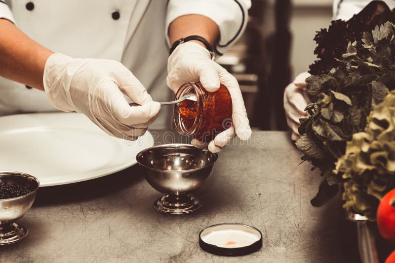 Chef is Cooking Appetizer of Caviar on a Metal Table of Restaurant ...