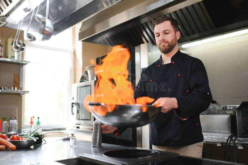 Chef Cooking and Doing Flambe on Food in Restaurant Kitchen Stock Image ...