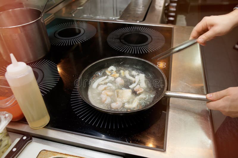 Chef is Cooking Fish in Boiling Stock, Toned Stock Photo - Image of ...