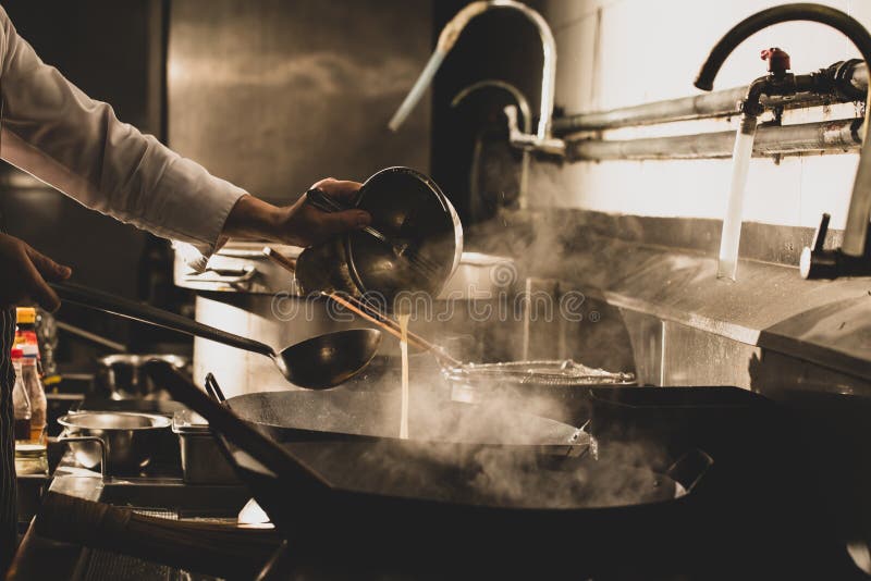 Chef cooking in kitchen stock photo. Image of dramatic - 184812824