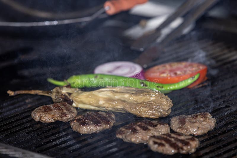 Chef is Cooking Meatballs on the Grill. Cut the Meatballs into Pieces ...