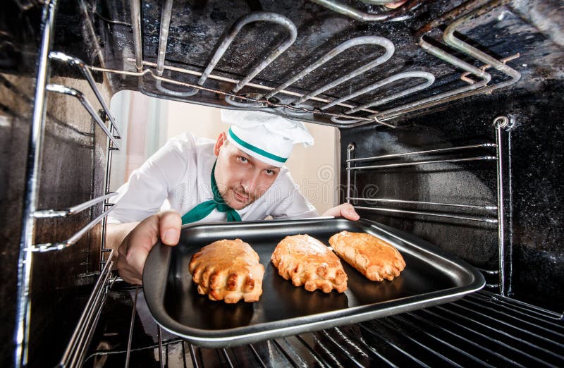 Chef cooking in the oven. stock photo. Image of hold - 42216484