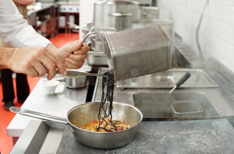 Chef is Cooking Pasta at Commercial Kitchen Stock Photo - Image of ...