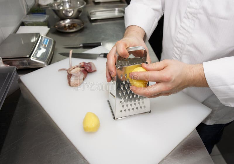 Chef is cooking potatoes stock image. Image of chef, kitchen - 28607643